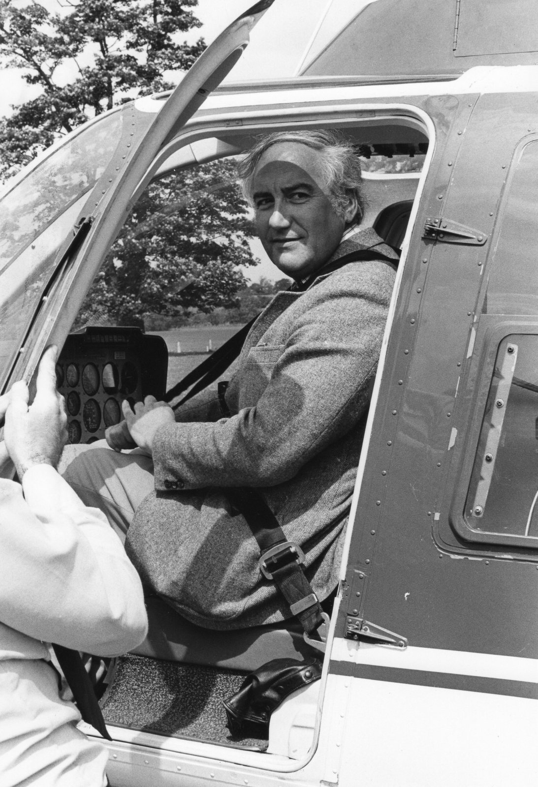 Eric Harrison sitting in helicopter cockpit – Granadaland